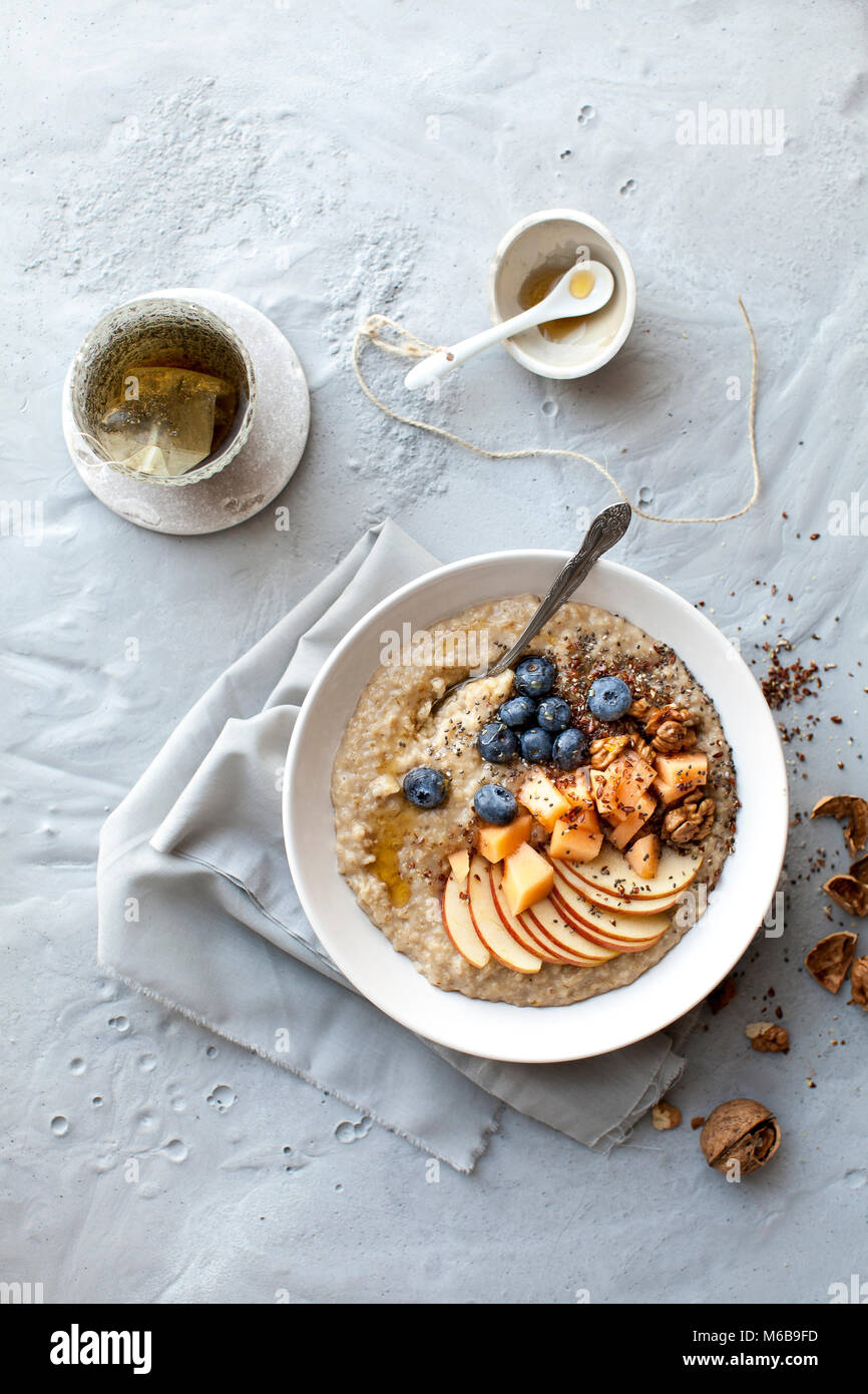 morning oat porridge with fresh fruits and tea Stock Photo - Alamy