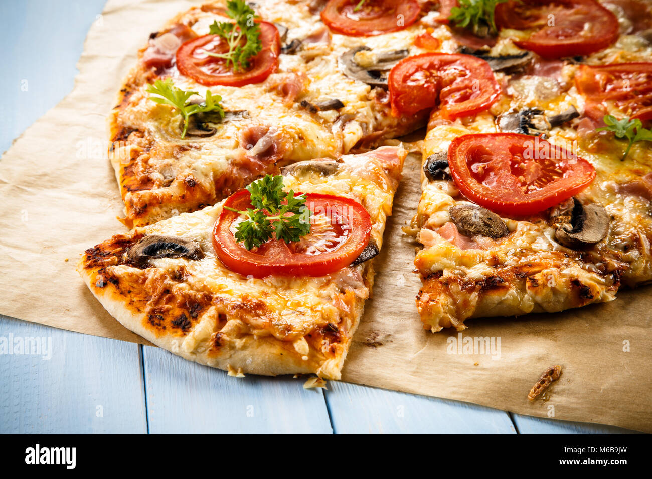 Pizza on wooden table Stock Photo - Alamy