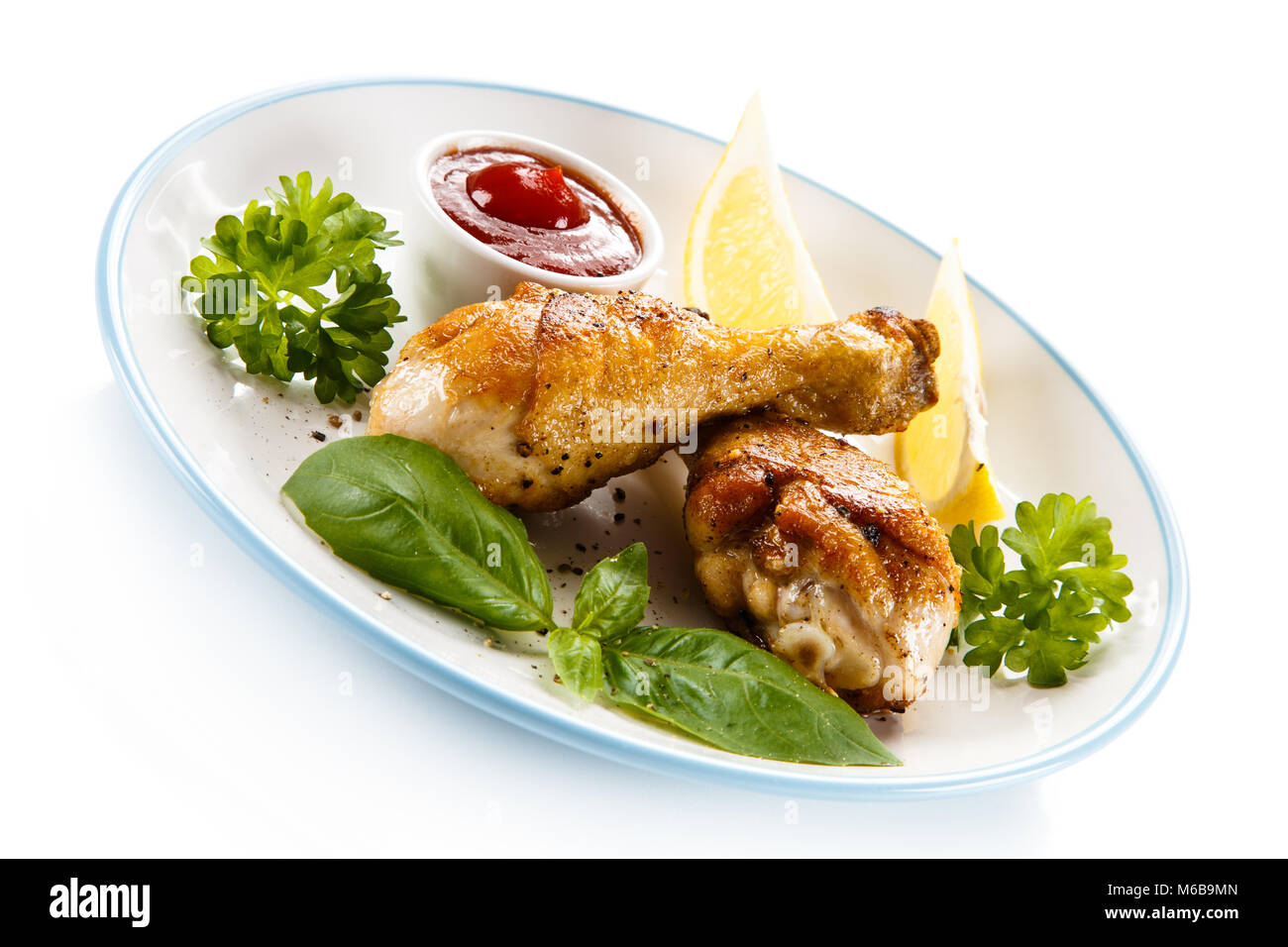 Grilled chicken drumsticks and vegetables Stock Photo - Alamy