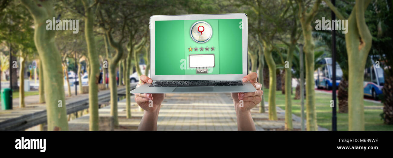 Composite image of cropped hands holding laptop Stock Photo - Alamy