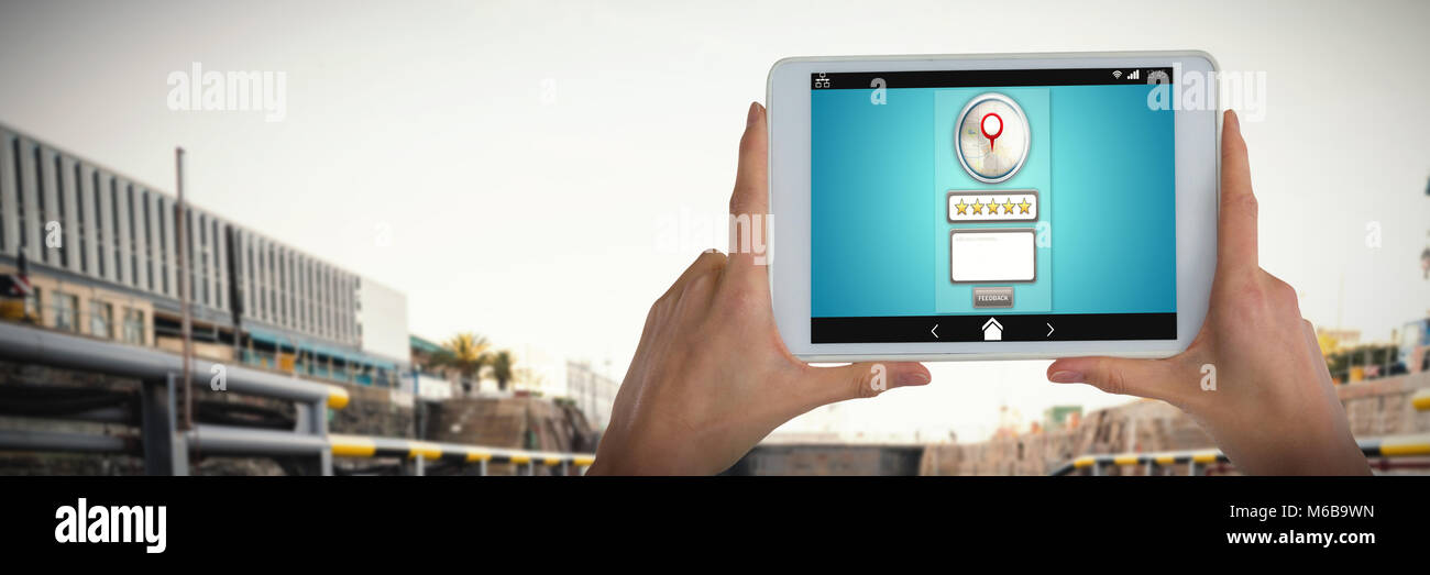 Composite image of womans hand holding digital tablet Stock Photo - Alamy