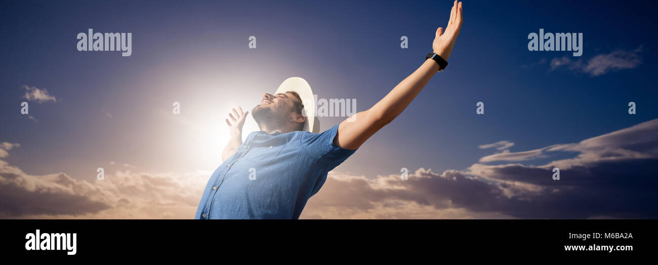 Composite image of happy man raising his arms up Stock Photo - Alamy