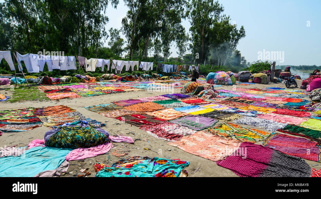 Agra, India - Jul 13, 2015. People dye and dry traditional clothes on ...