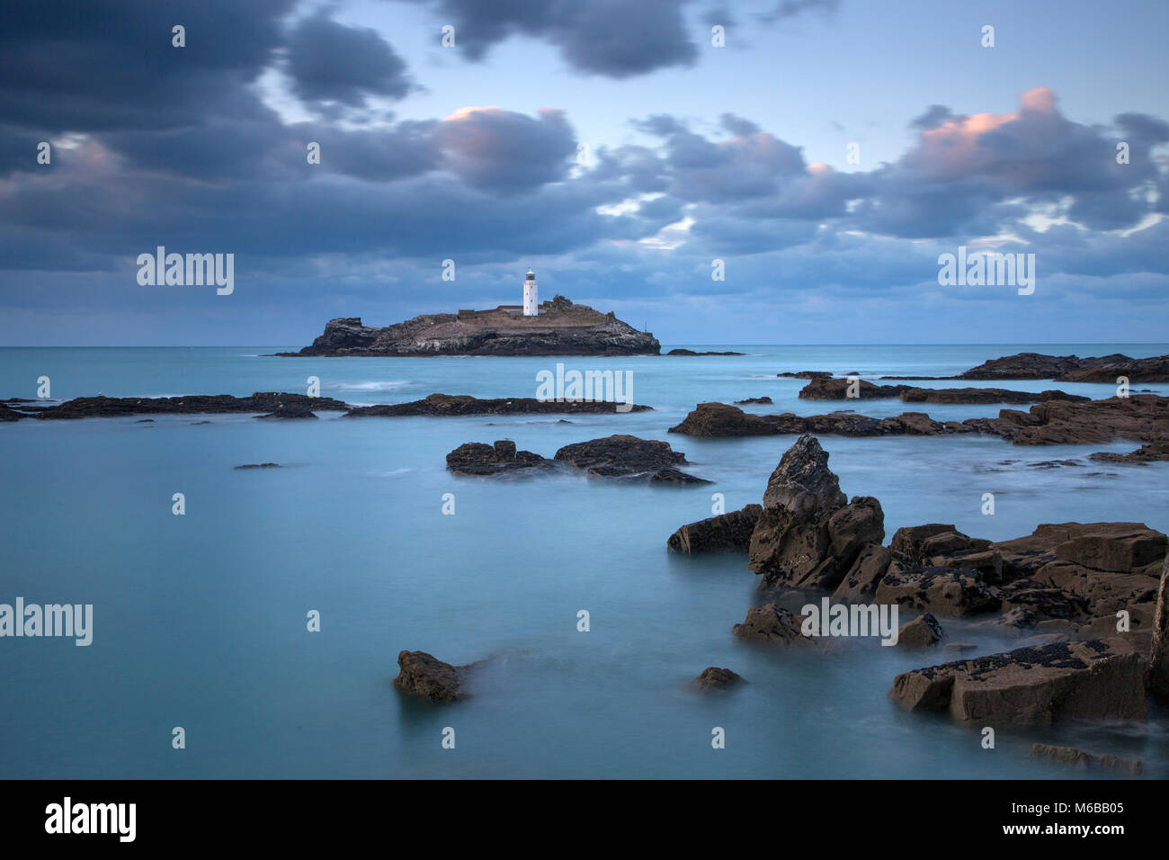 Sunset over Godrevy Lighthouse on Godrevy Island in St Ives Bay with ...