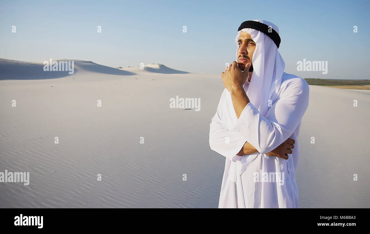 Stately Arabian UAE Sheikh man looks hard into distance and pond Stock ...