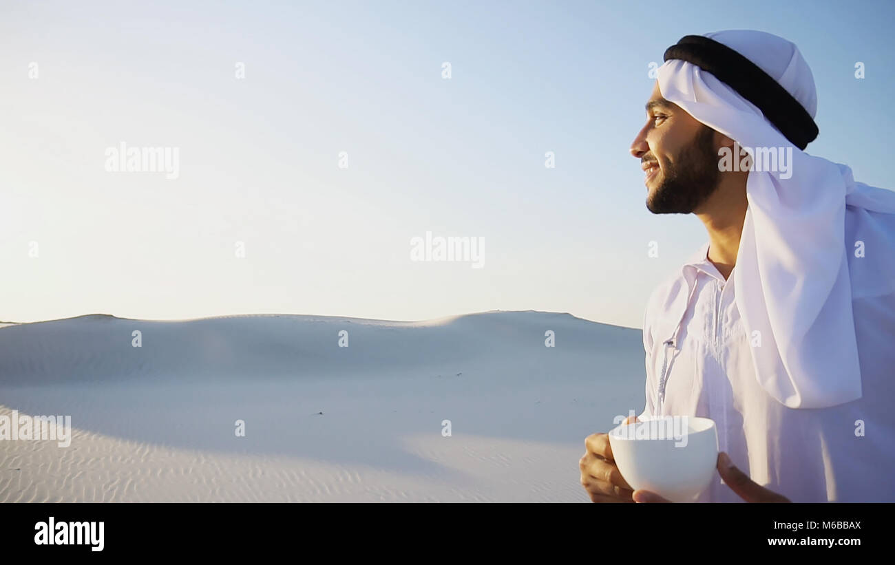Good morning for male sheikh in middle of huge desert over cup o Stock ...