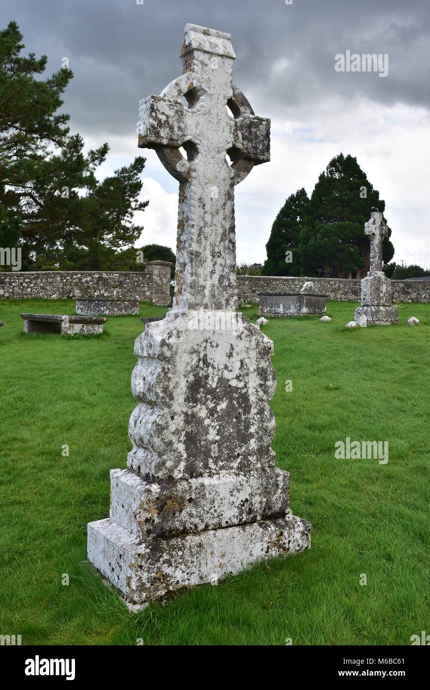 Weathered tombstone with Celtic cross on grounds of monastery of ...