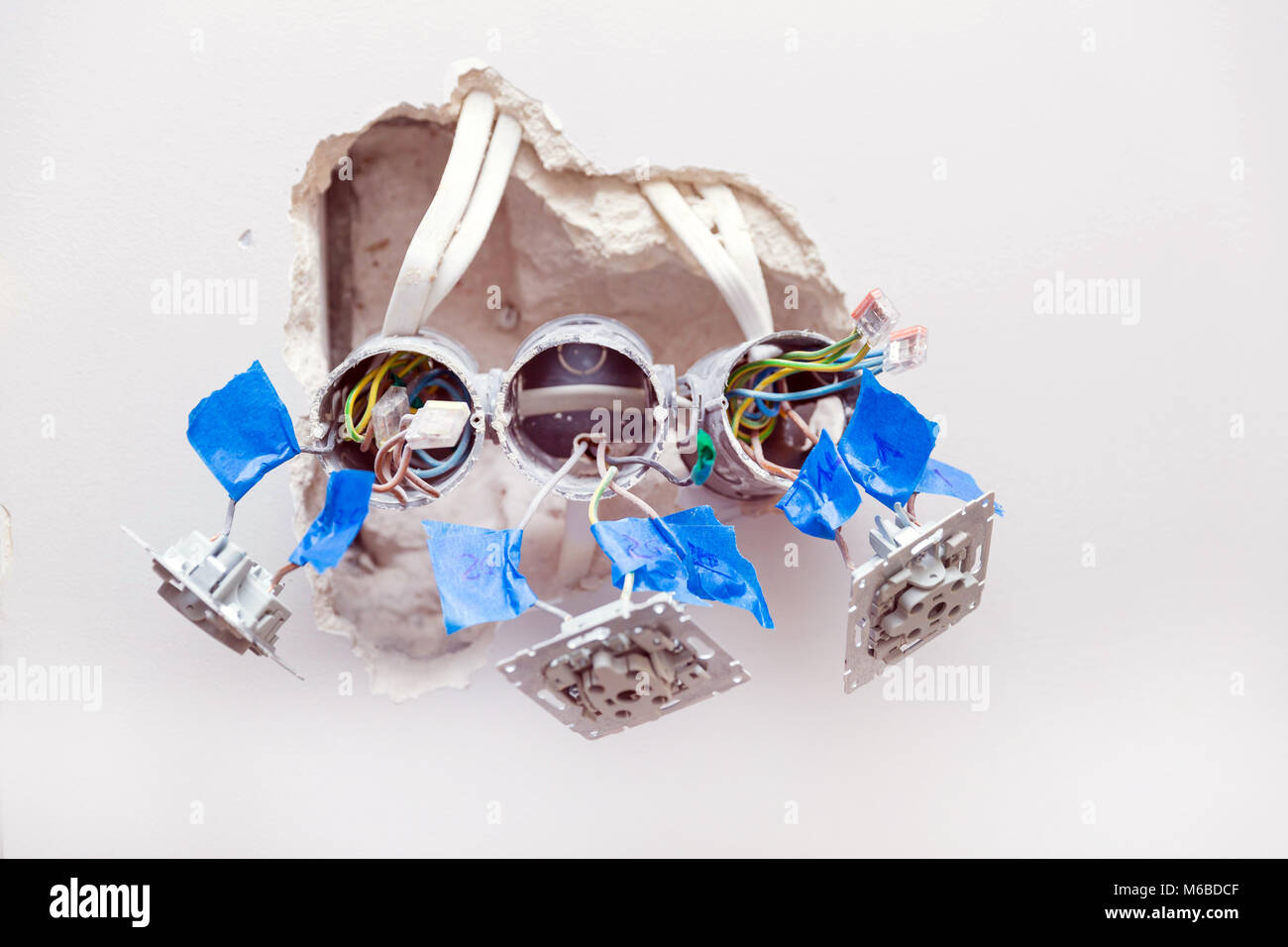 Repairing damaged sockets, installing new Stock Photo - Alamy