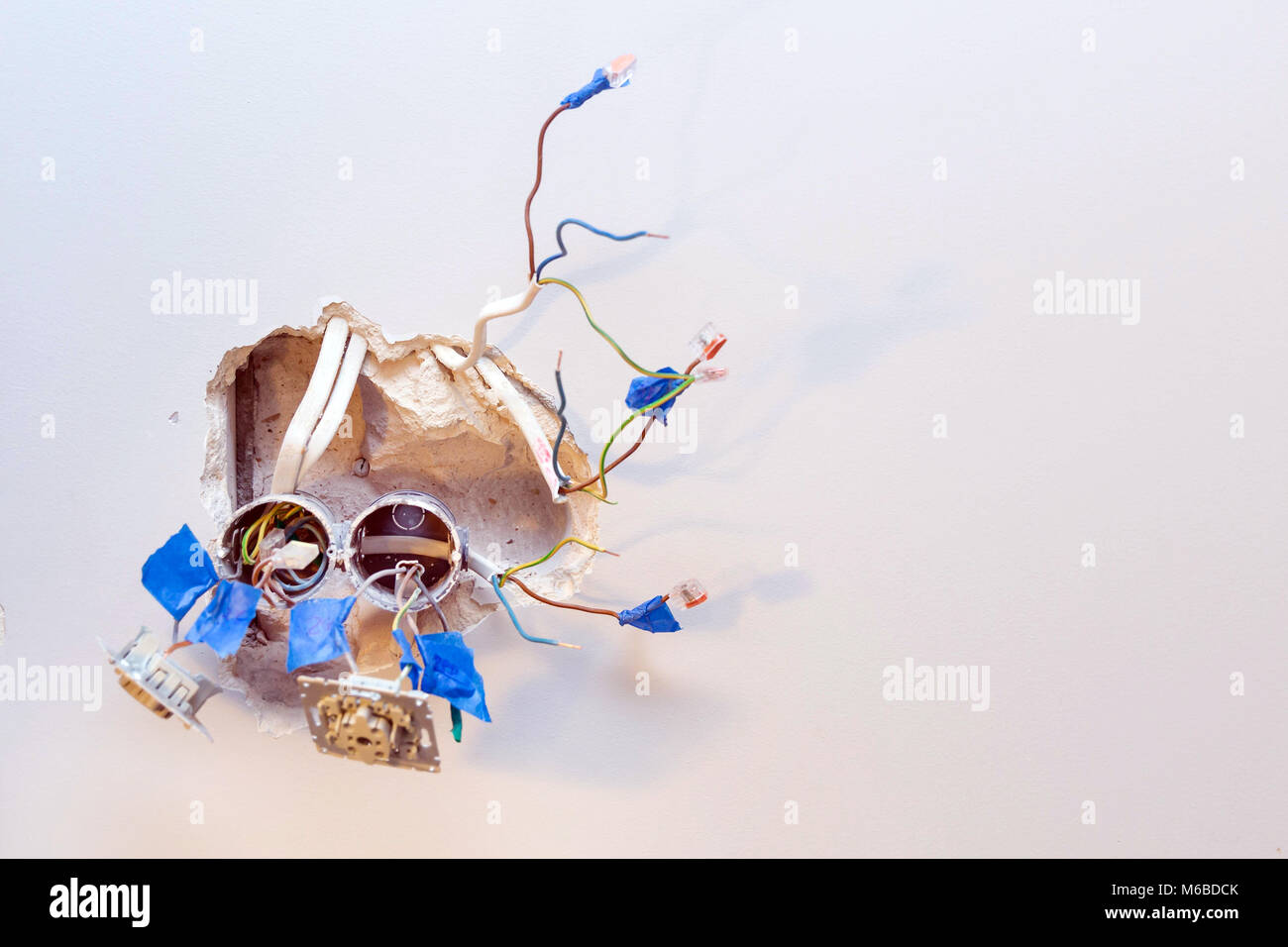 Repairing damaged sockets, installing new Stock Photo - Alamy