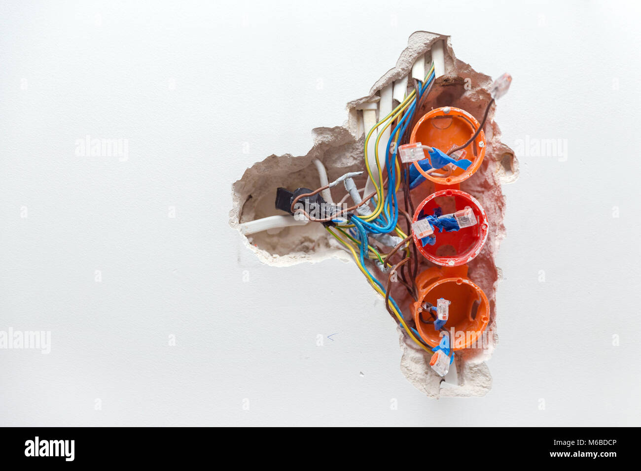 Repairing damaged sockets, installing new Stock Photo - Alamy