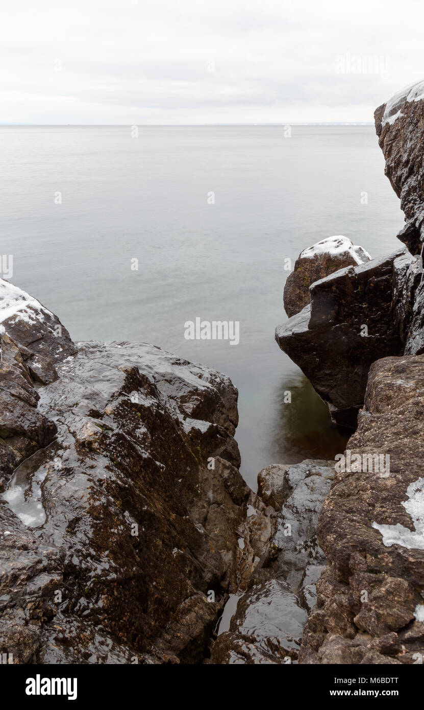 Cliffs at sea in winter with snow Stock Photo - Alamy