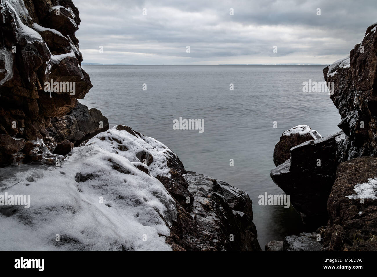 Cliffs at sea in winter with snow Stock Photo - Alamy