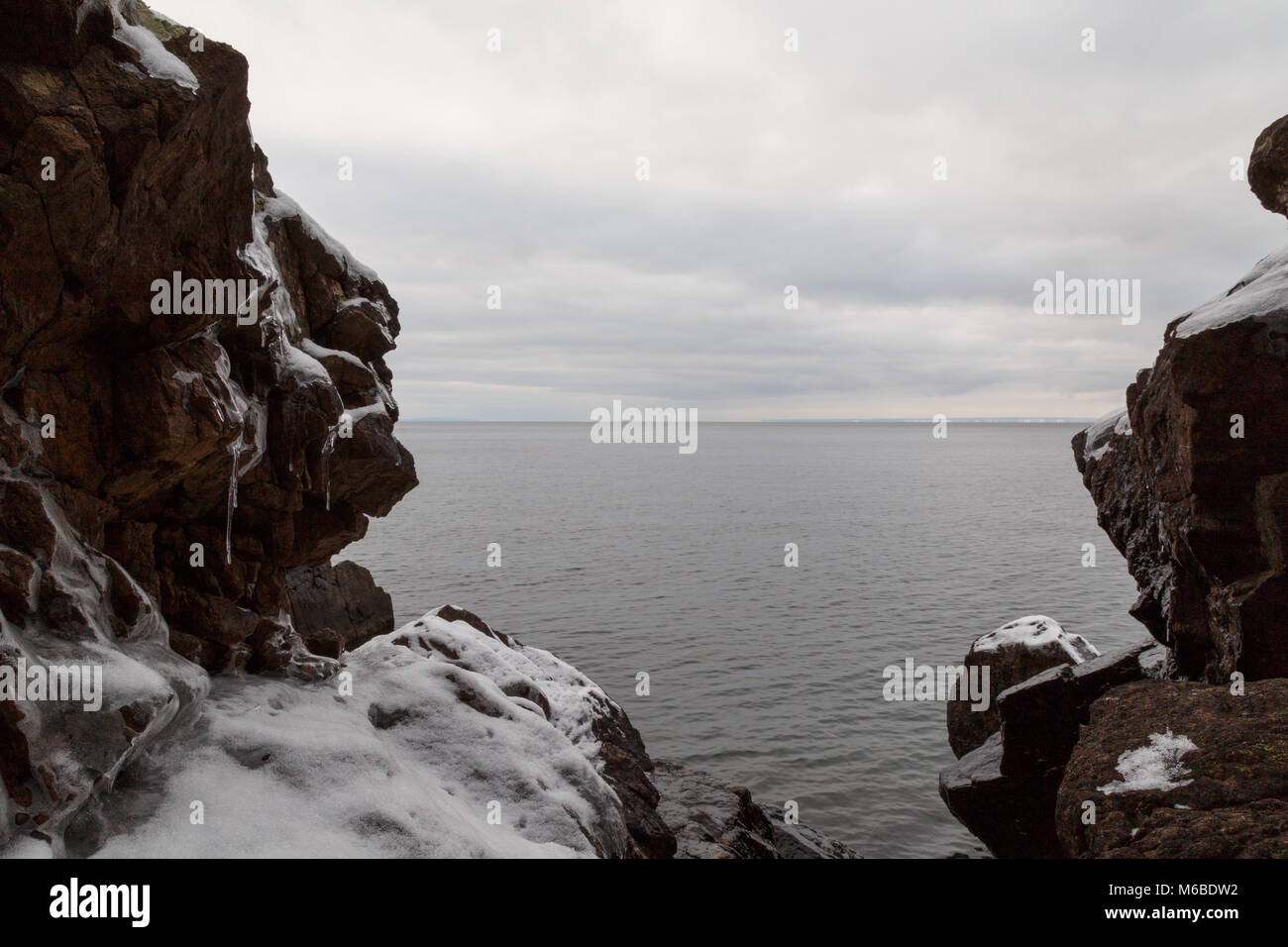 Cliffs at sea in winter with snow Stock Photo - Alamy