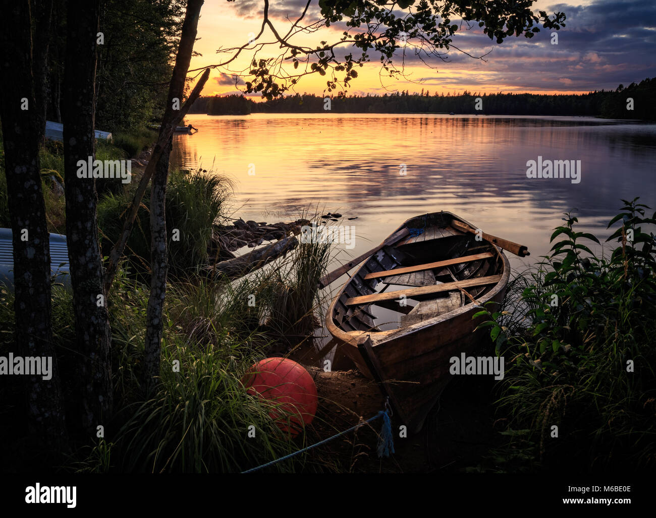 Boat on land under tree Stock Photo - Alamy