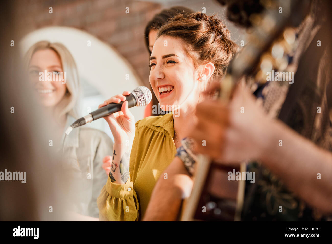 Entertianment at a wedding. A female singer is interacting with the ...