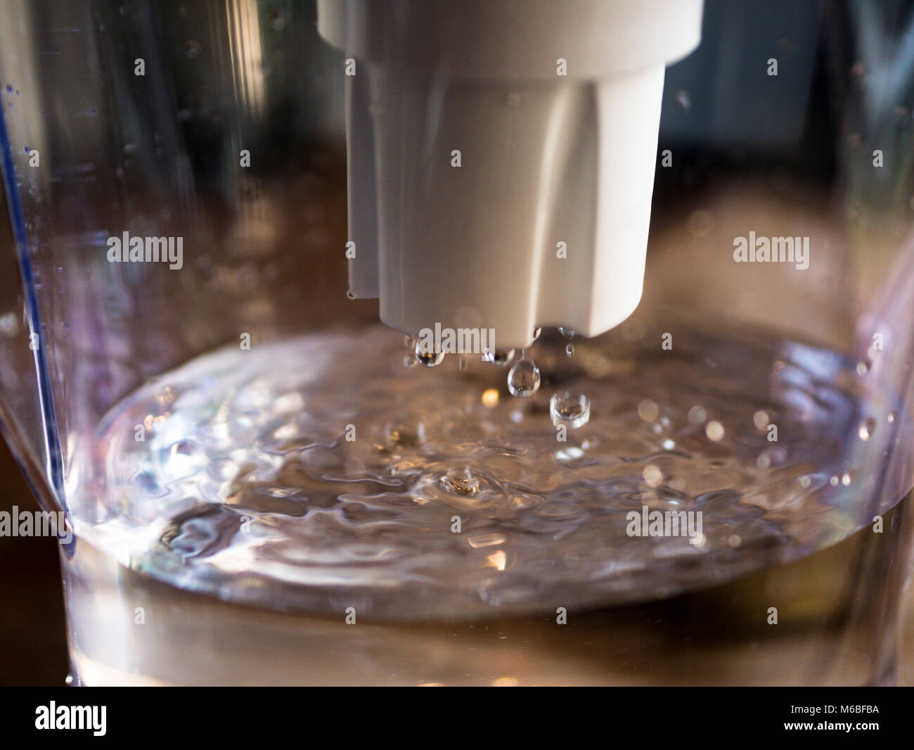 Water filtering into a jug Stock Photo - Alamy