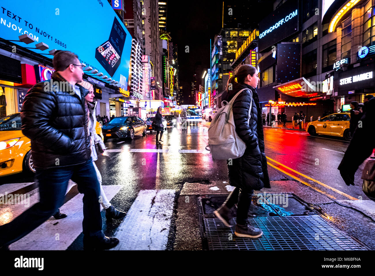 People walking in Times Square at night, midtown Manhattan, New York ...