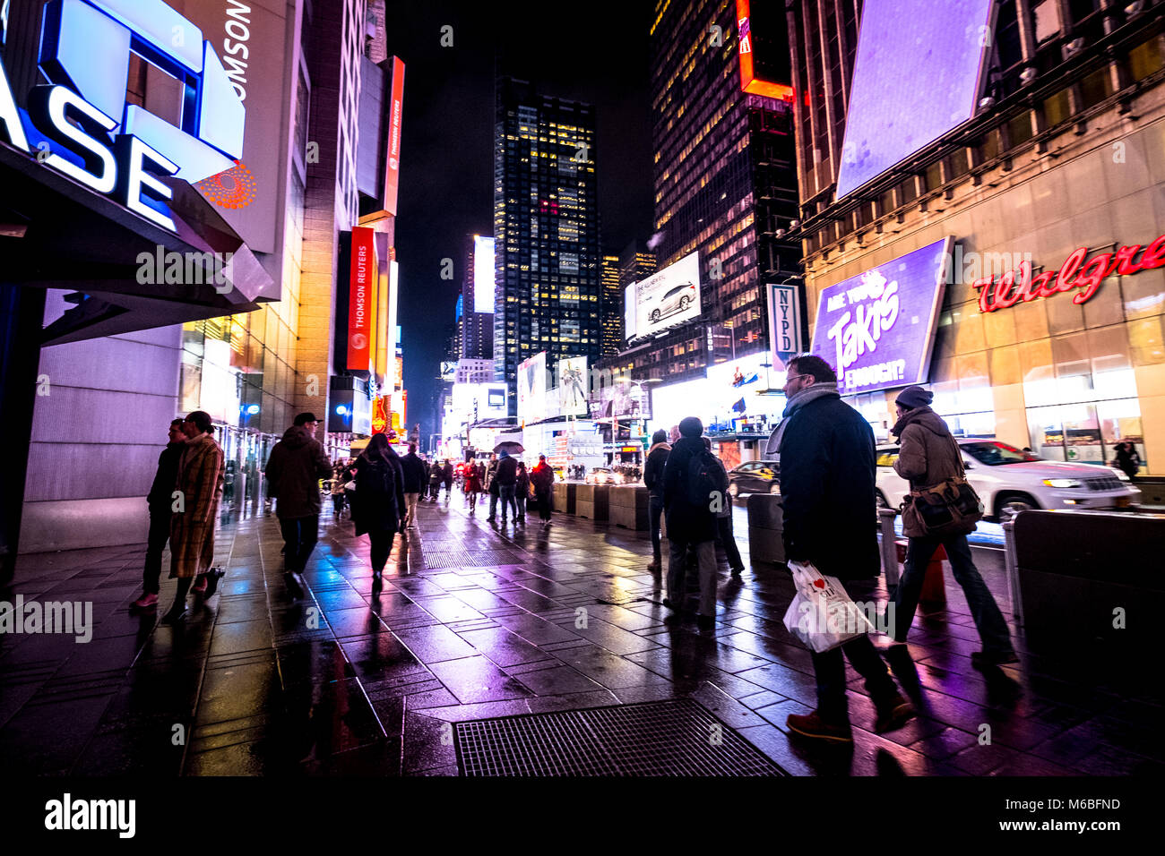 People walking in Times Square at night, midtown Manhattan, New York ...