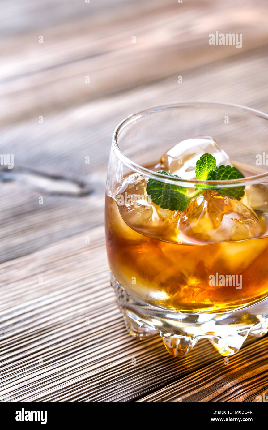 Glass of rum on the wooden background Stock Photo - Alamy