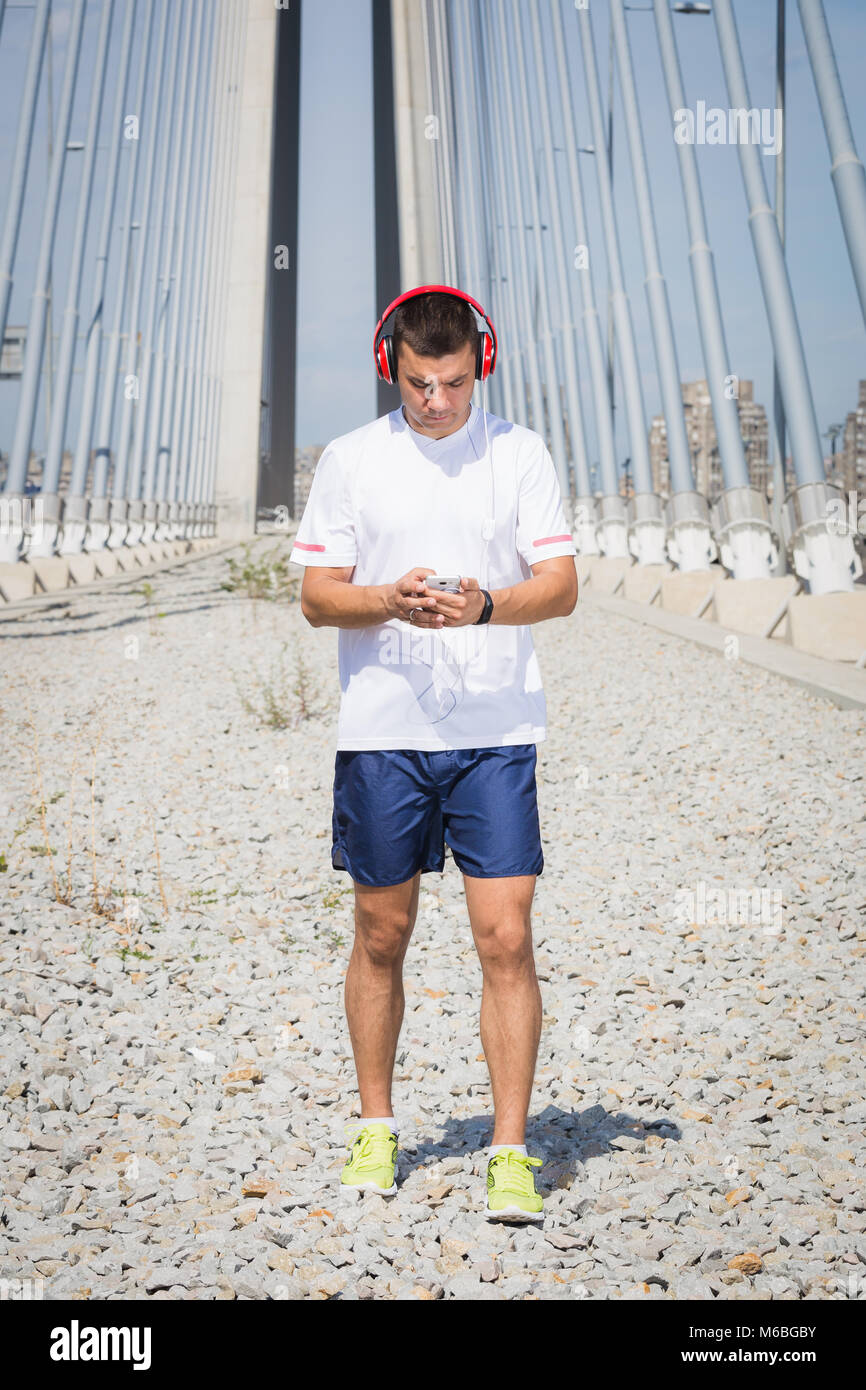 Male runner using smart phone hi-res stock photography and images - Alamy
