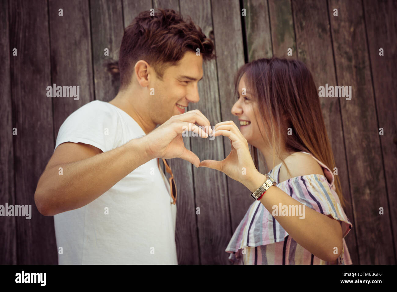 Young married couple making heart hi-res stock photography and images ...