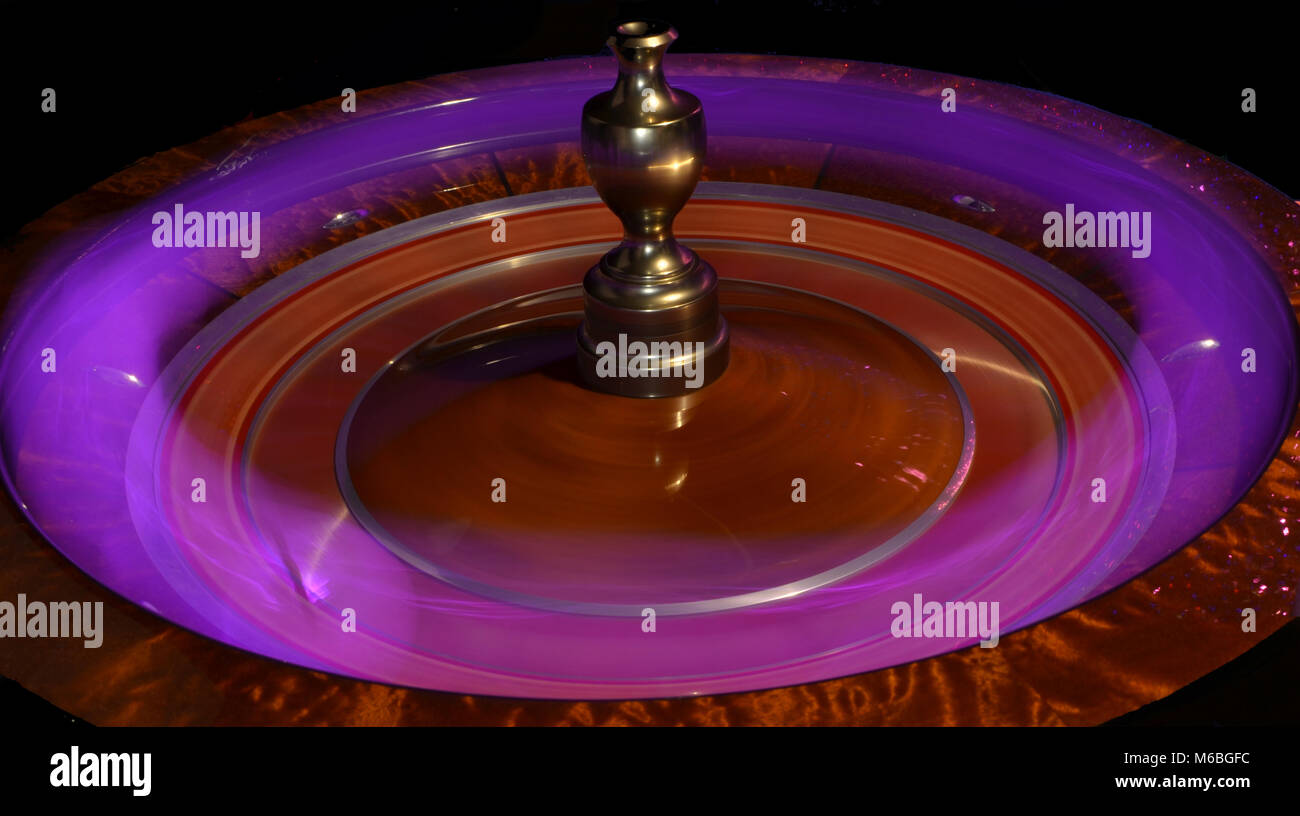 Roulette wheel with pink light streak Stock Photo - Alamy
