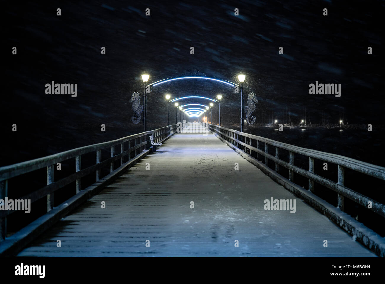 The snowy pier at night Stock Photo - Alamy