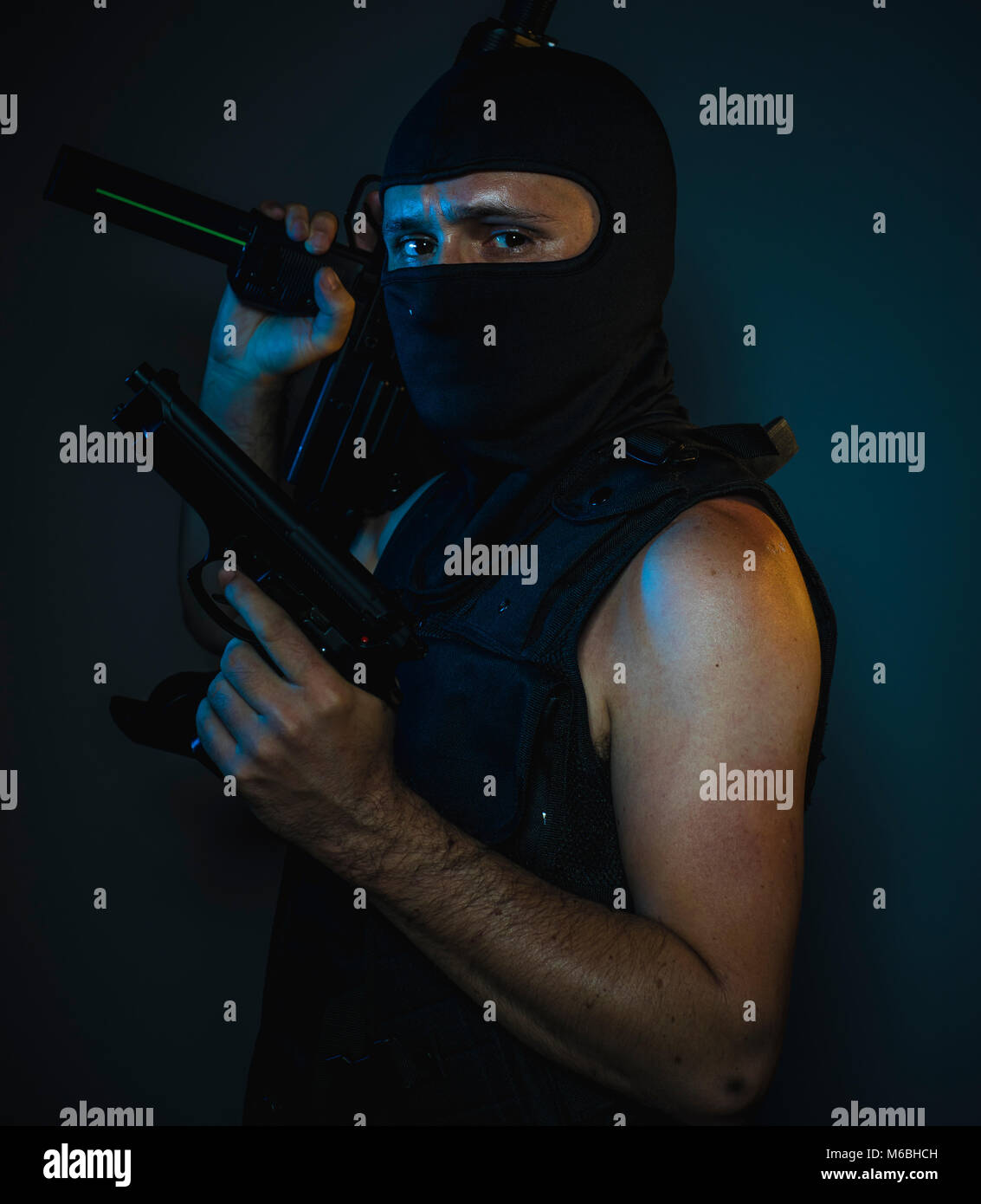 hit man, armed and dangerous man with balaclava and bulletproof vest ...