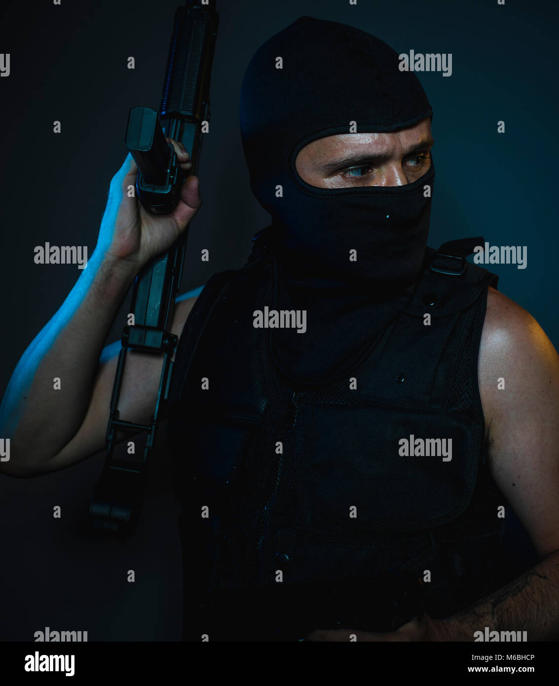 hit man, armed and dangerous man with balaclava and bulletproof vest ...