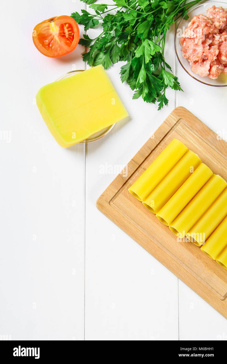 Italian pasta cannelloni. Raw tube for stuffing stuffing surrounded by ...