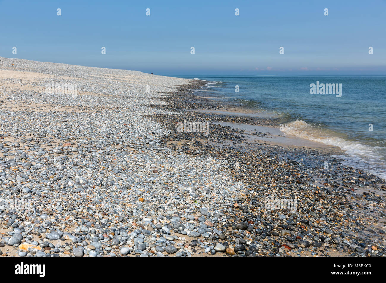 Pebble beach at German island Dune with blue sky Stock Photo - Alamy