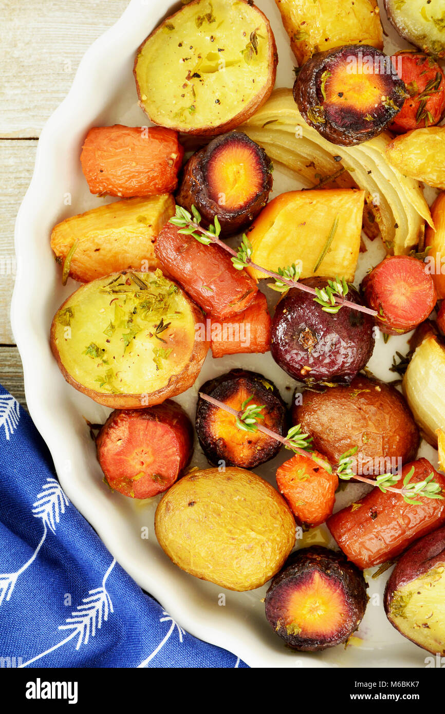 Healthy roasted root vegetables from overhead in vertical format and ...