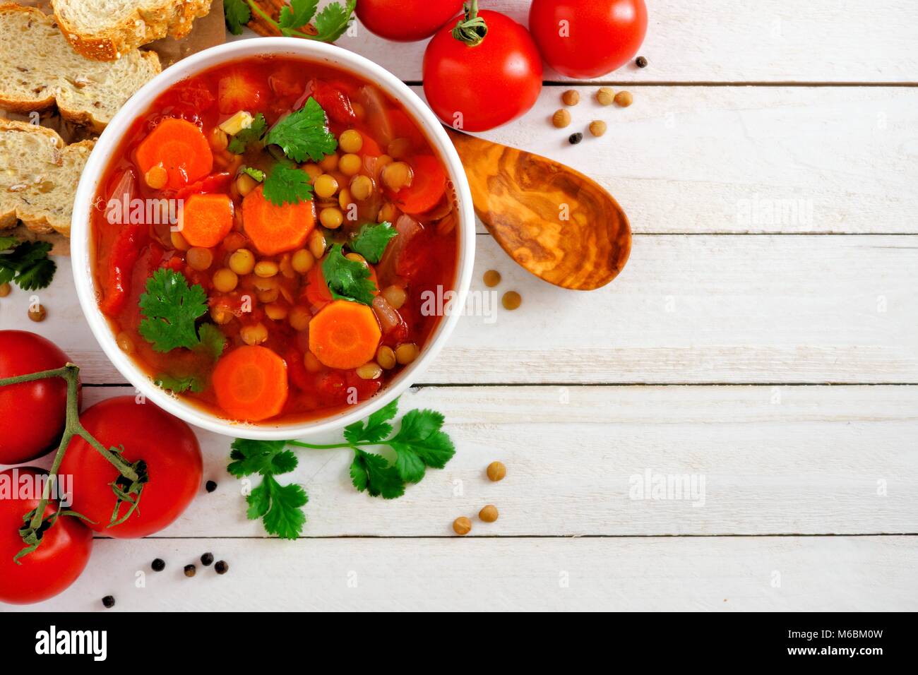 Homemade tomato, lentil soup, above view corner border with copy space ...