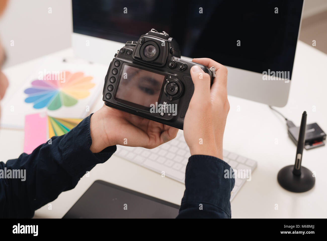 Photographer working at desk in modern office Stock Photo - Alamy