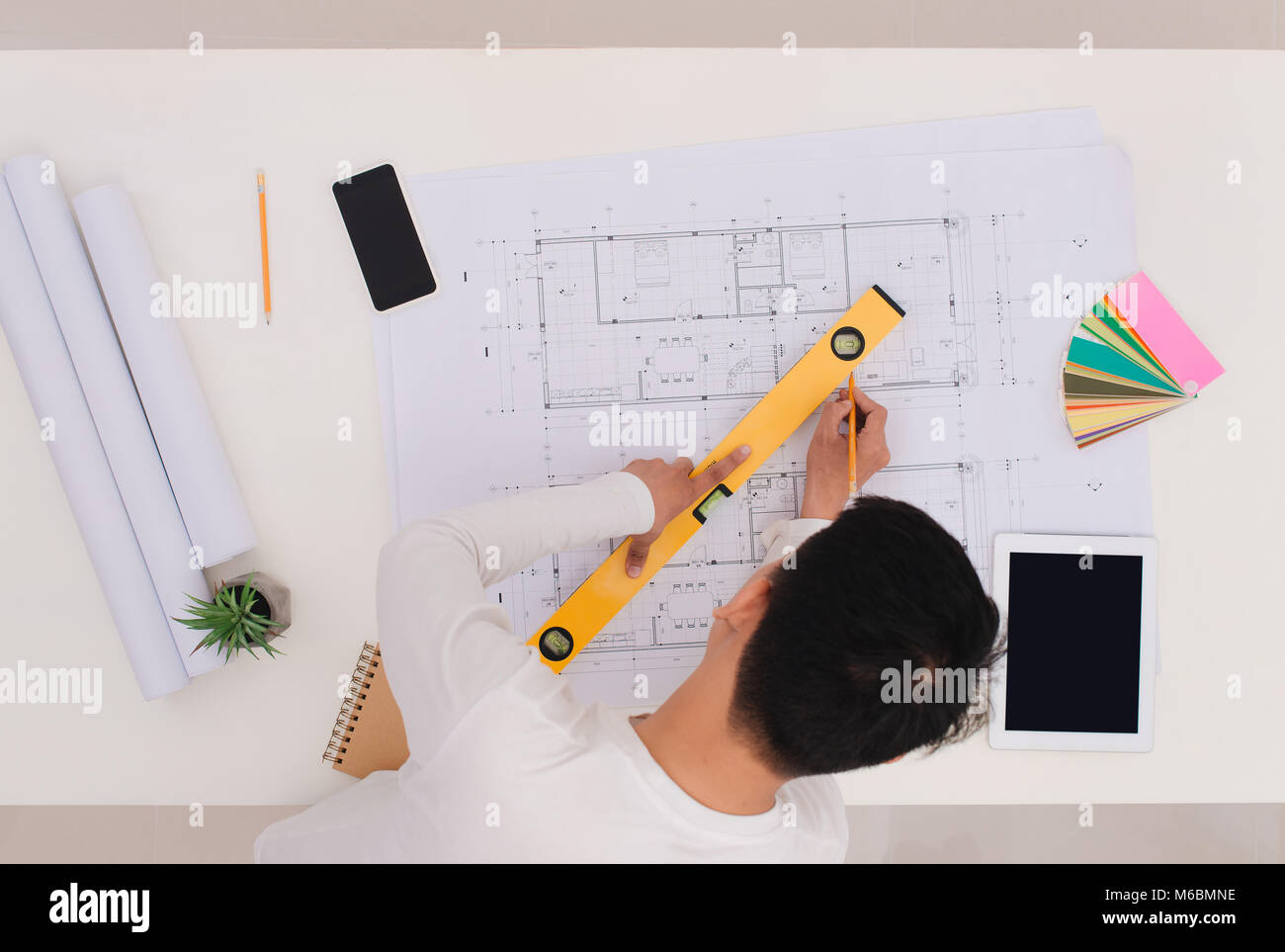 Top view of male architect drawing on architectural project Stock Photo ...