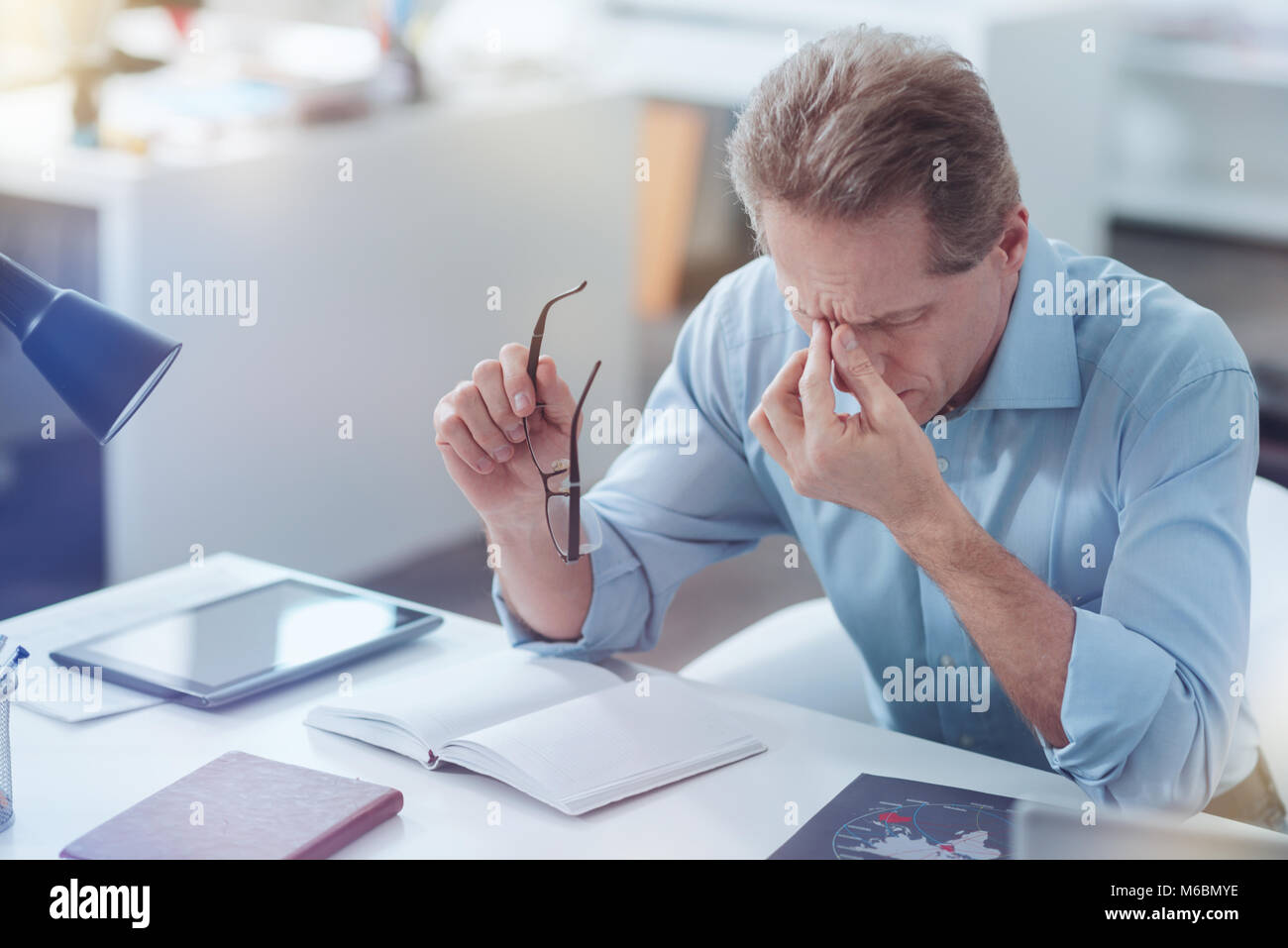 Sad tired man trying to rest from work Stock Photo - Alamy