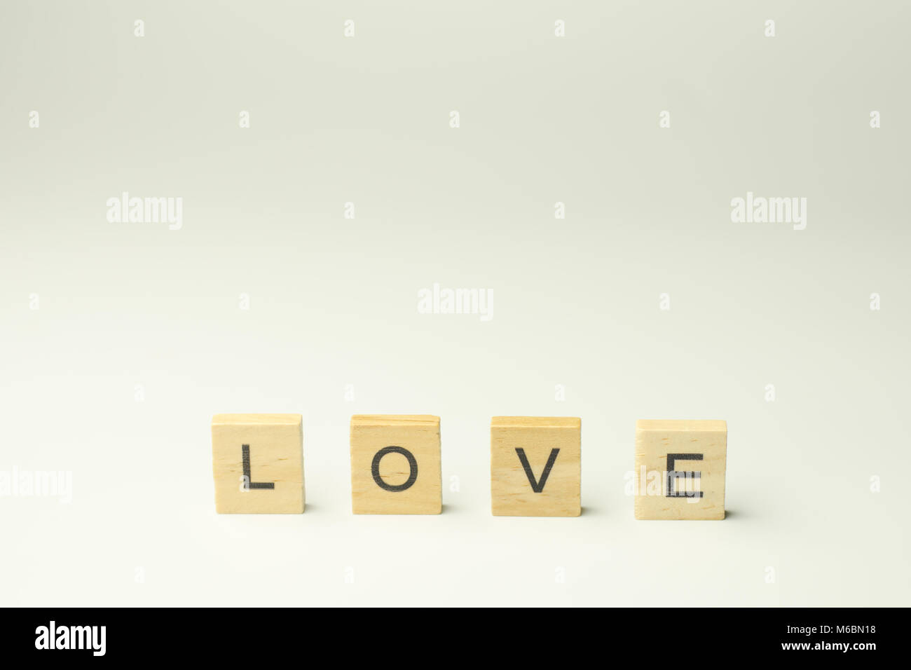 Text wooden blocks spelling the word LOVE on white background Stock ...