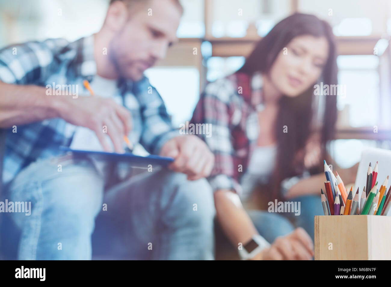 Silhouettes of two friends that working together Stock Photo - Alamy