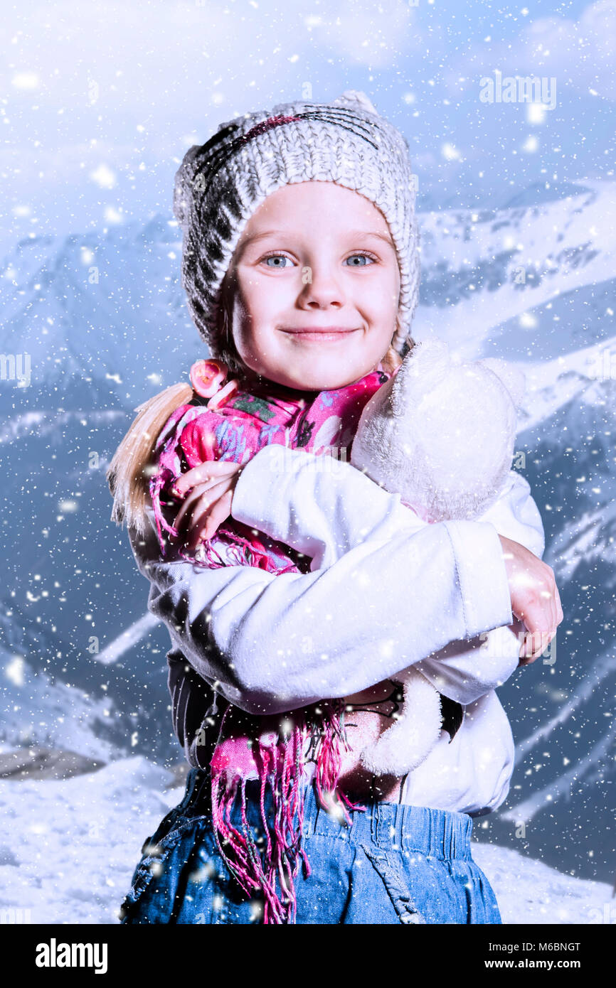 Girl hugging teddy bear in winter scenario Stock Photo - Alamy