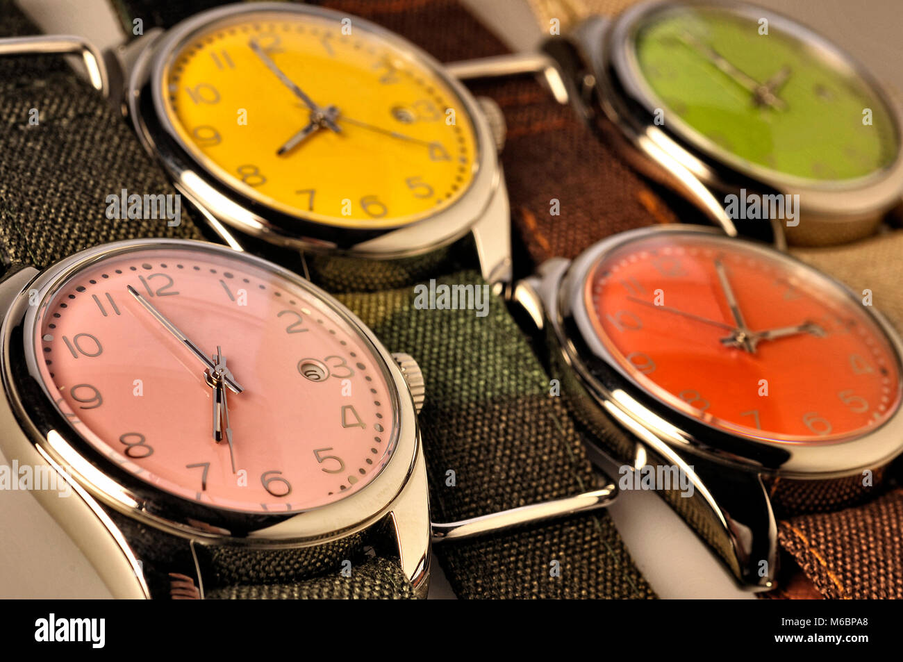 Four colorful watches in perspective and low deep of field Stock Photo ...