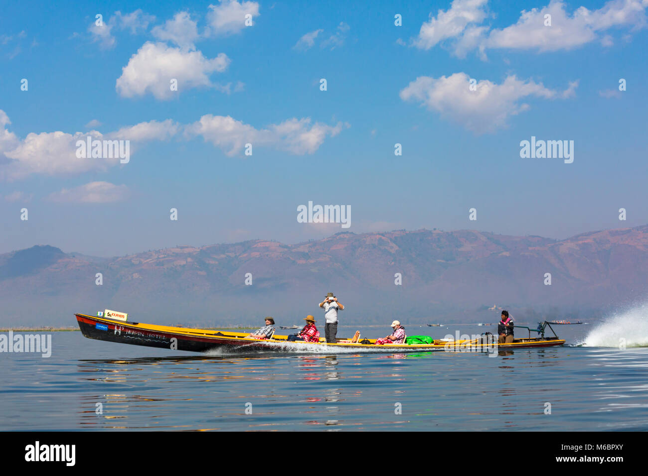 Tourists enjoying a ride in long tail boat at Inle Lake, Shan State ...