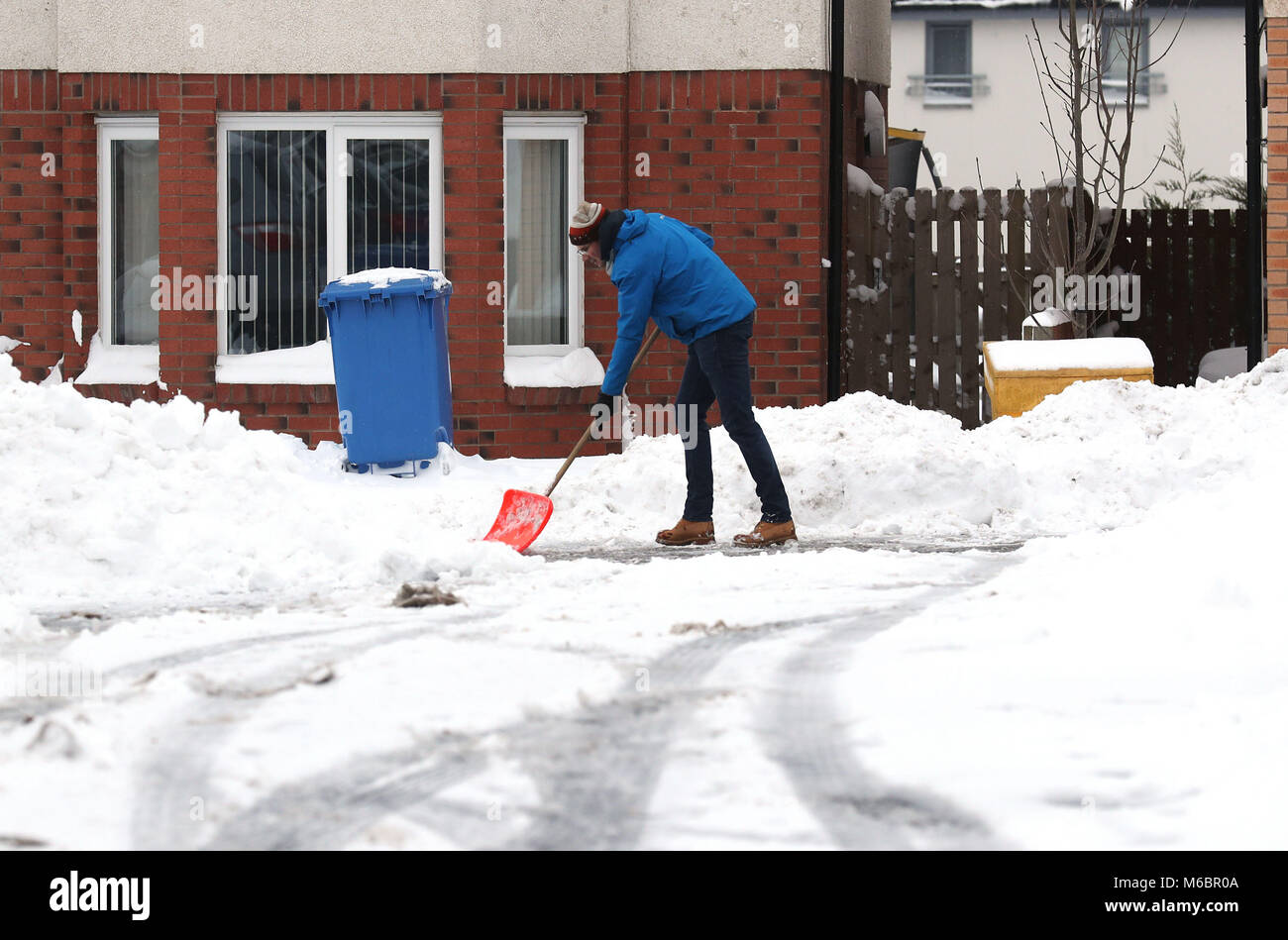 Snow is cleared from the street in Larbert, Falkirk, as hundreds of ...