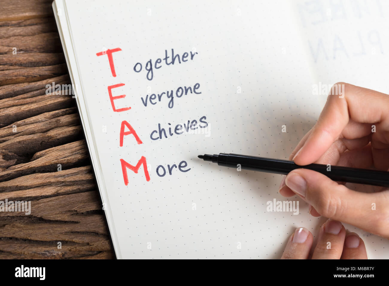 Close-up Of A Businessperson Writing Team Concept On Notebook Stock ...