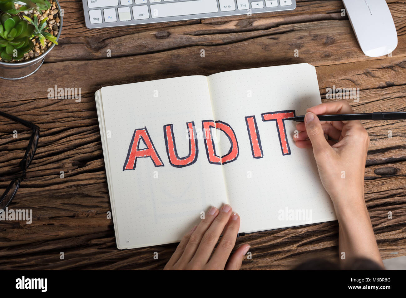 Elevated View Of An Auditor Writing Audit Concept On Notebook Stock ...