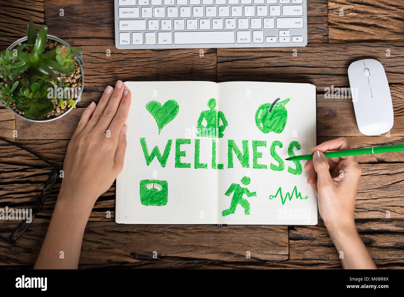 High Angle View Of A Human Hand Drawing Wellness Concept On Notebook ...