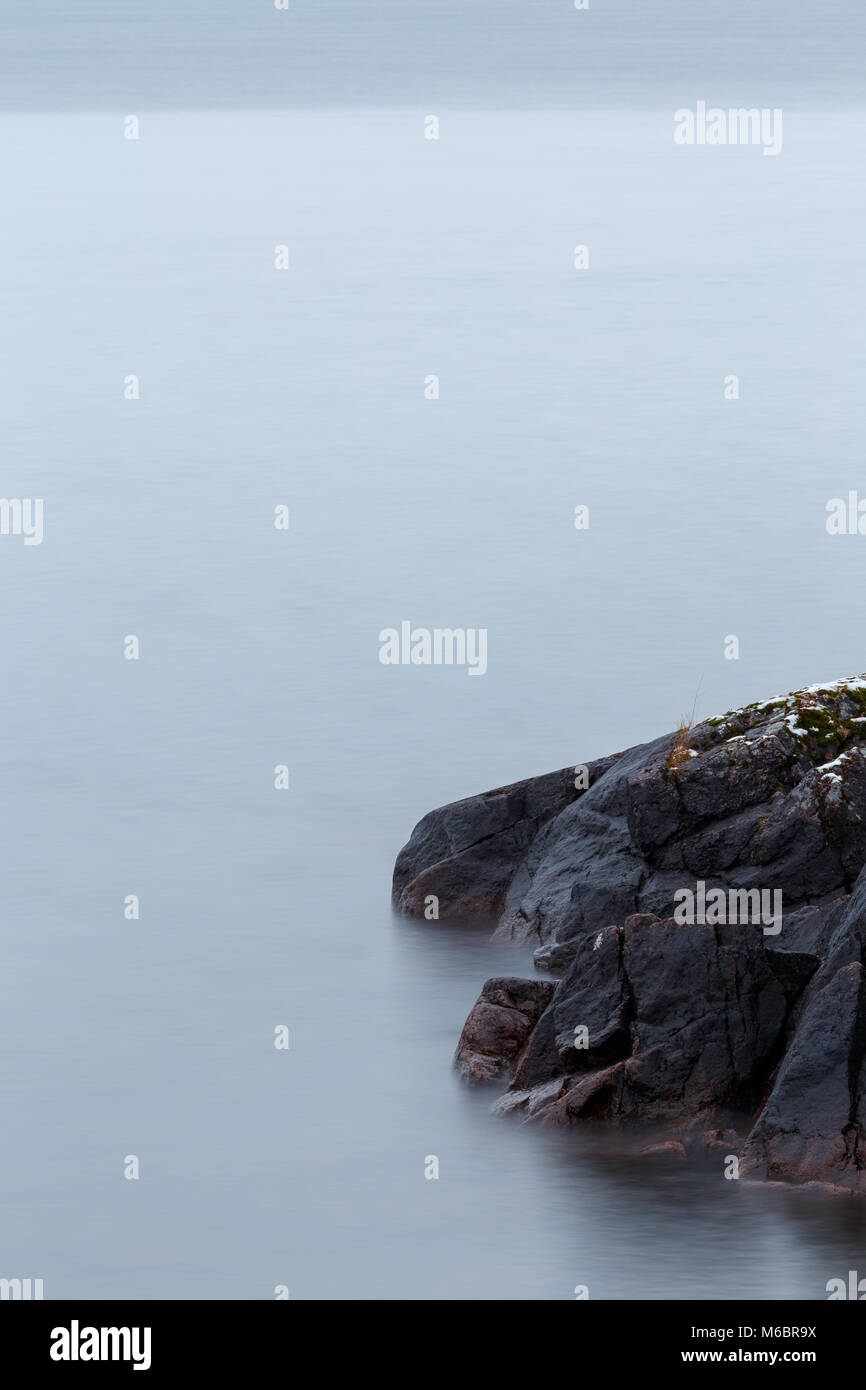 Rocks in foreground at lake Stock Photo - Alamy