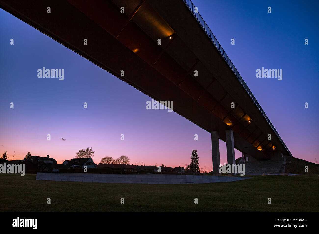 Looking up on bridge with sunset in the background Stock Photo - Alamy