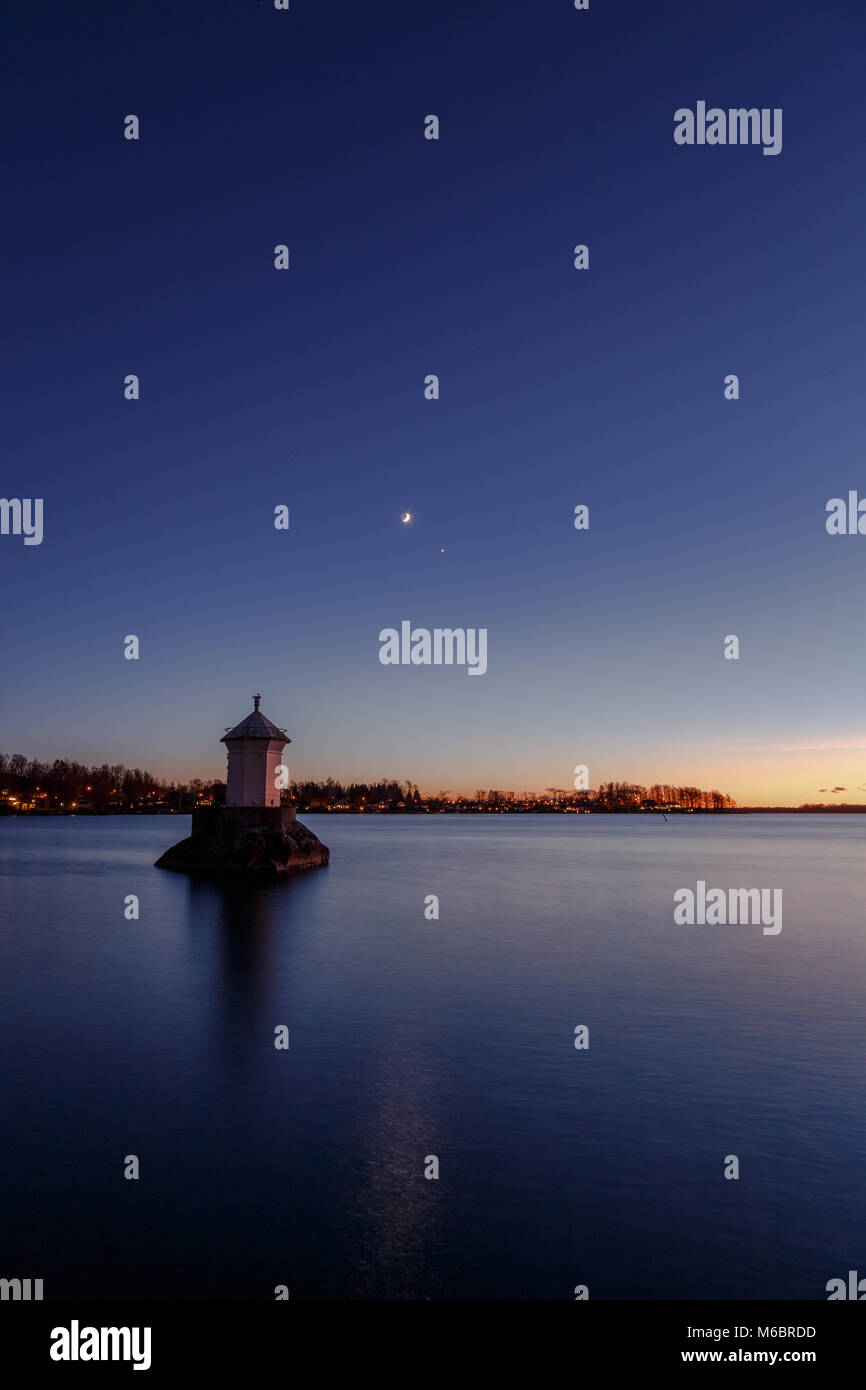Small lighthouse at sunset Stock Photo - Alamy