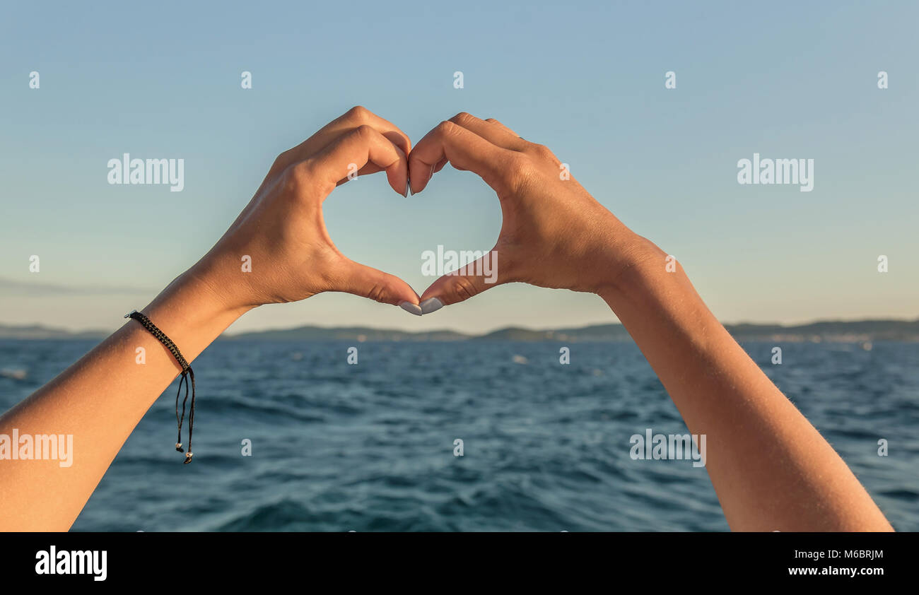Hands in the shape of heart against the background of the sea Stock ...