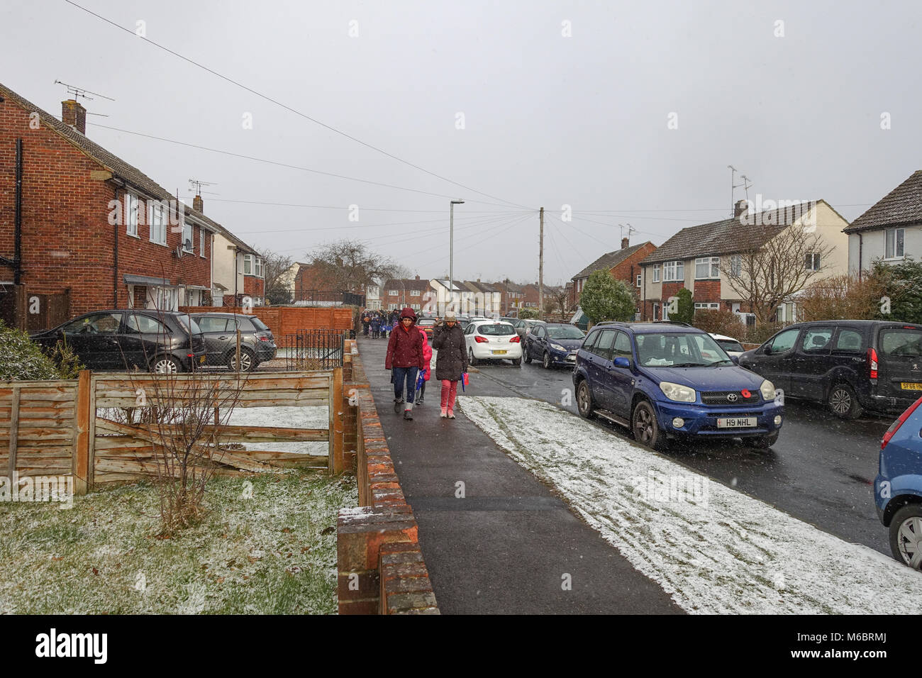 Snow falling in Reading during the school pickup as school children ...